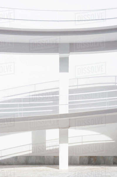 White smooth ramps or inclines with railings located outside modern ...