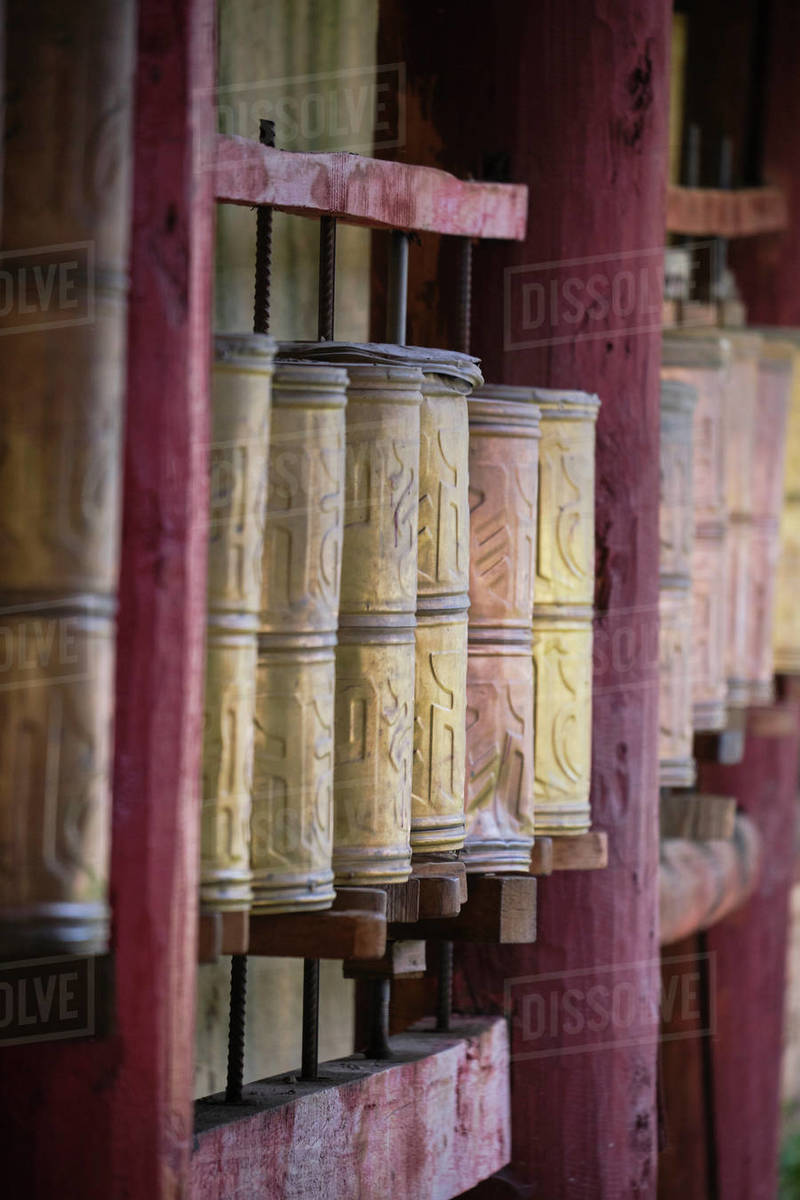 Old stone Tibetan rolls with sacred mantra consisting of sanskrit ...