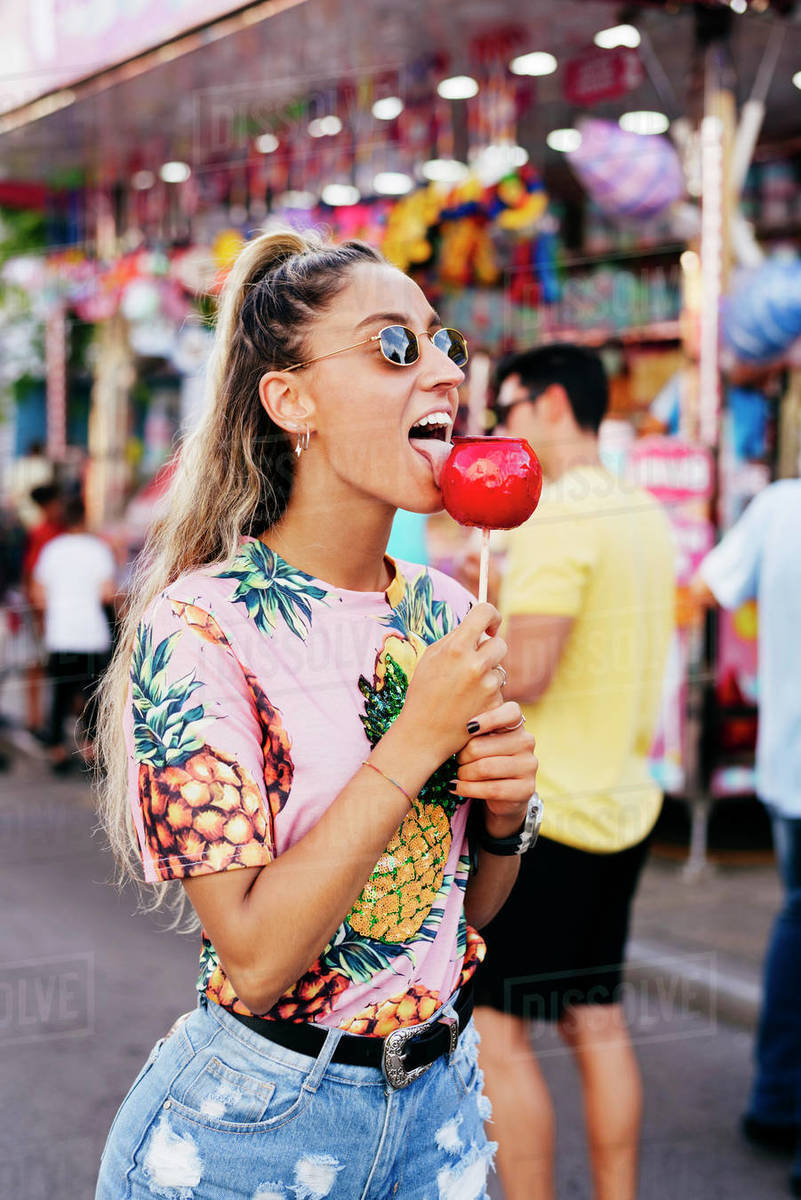 Cheerful lady having fun enjoying sweet candy apple - Royalty-free ...