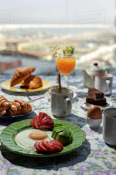 Homemade full healthy breakfast in sunlight with eggs, avocado ...