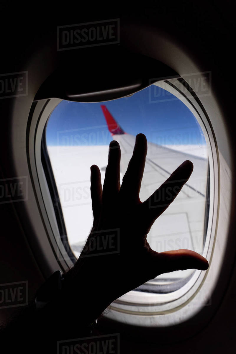 From above of faceless passenger waving during flight in aircraft ...