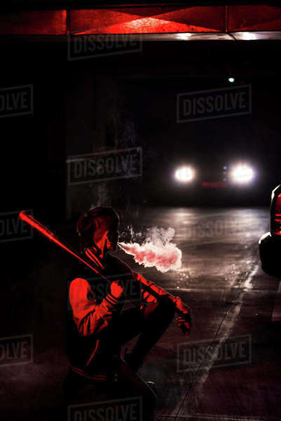 Side view of unrecognizable contemporary female crouching in bomber ...