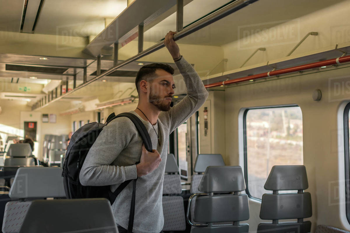 Focused young male passenger riding metro in daytime - Stock Photo ...
