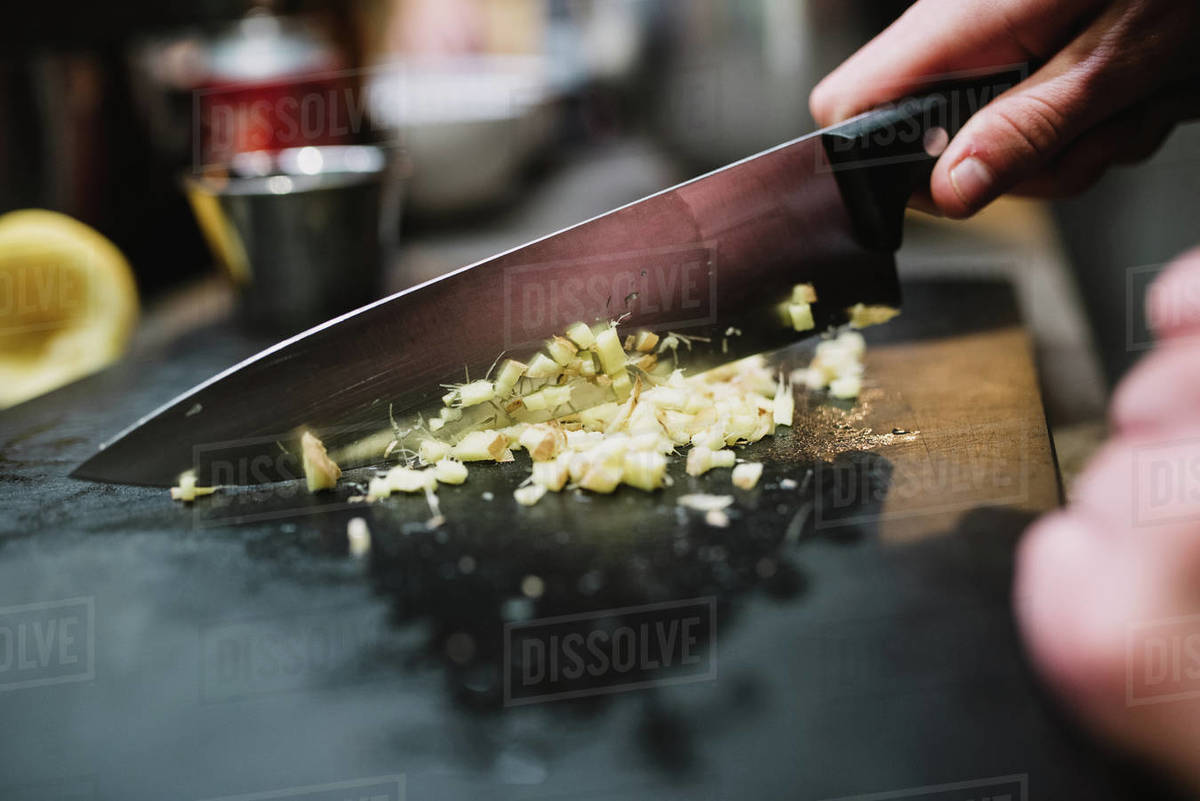 Closeup anonymous person chopping fresh ingredient with sharp knife ...