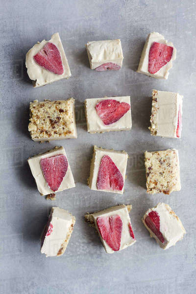 Top view of cut into pieces delicious homemade frost dessert with white ...