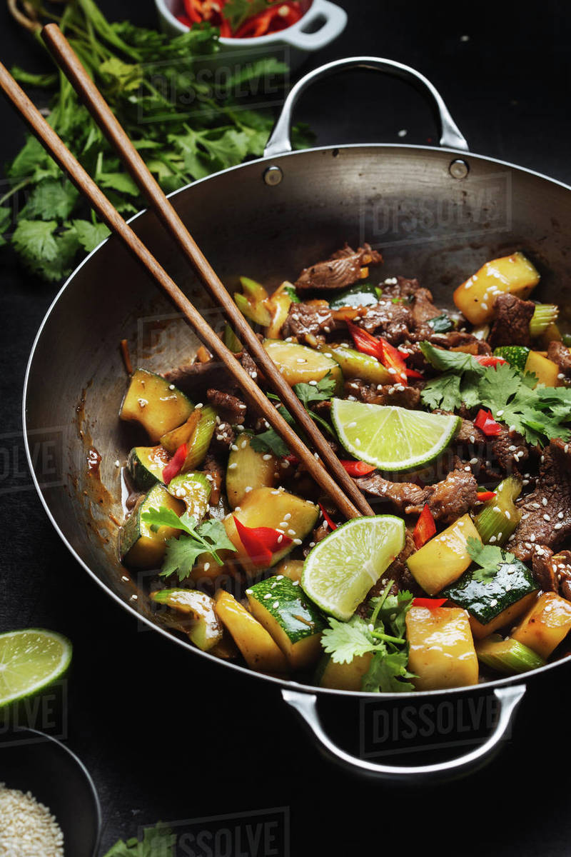 From above of Asian spicy wok stir fried dish with meat and zucchini ...