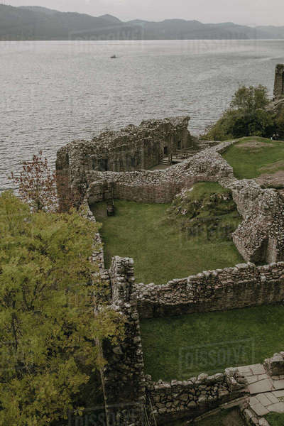 From above of stone walls of ancient castle located on green hill near ...