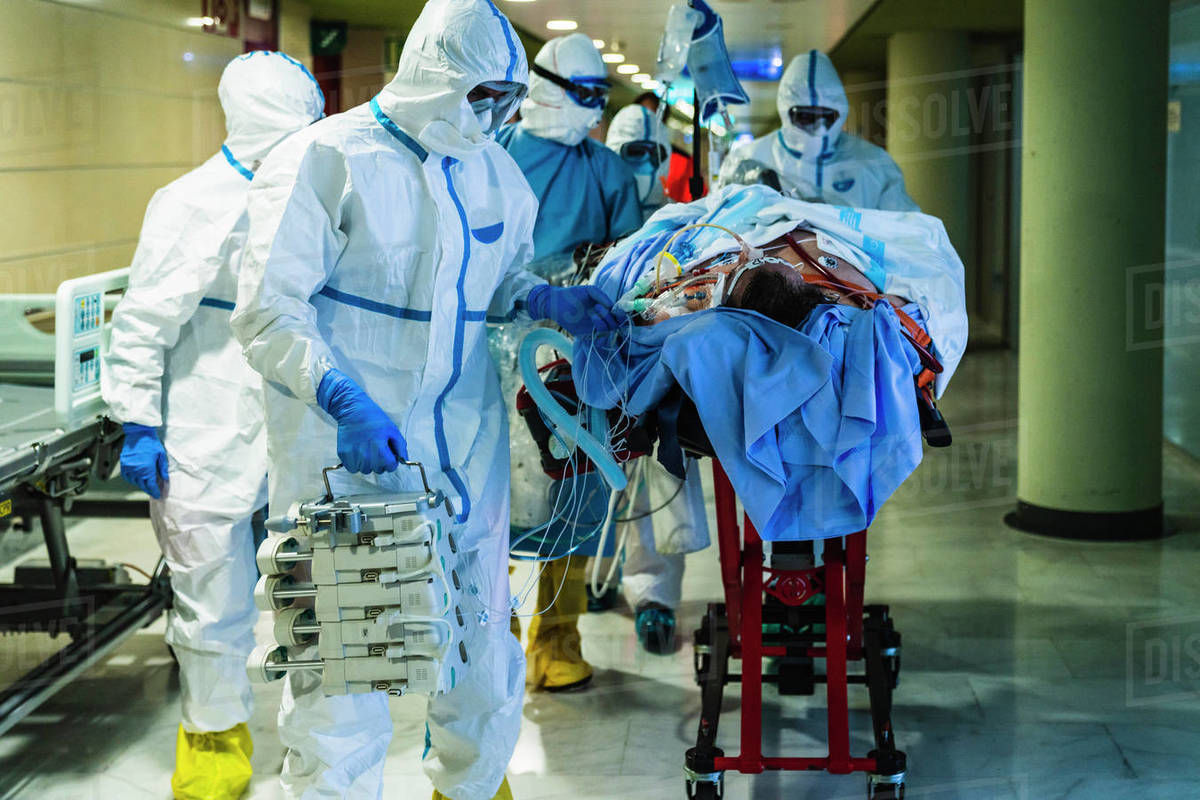 Group of unrecognizable professional doctors wearing protective masks ...