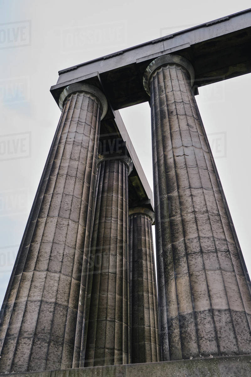 From below of high ancient light brown ribbed columns with concrete ...