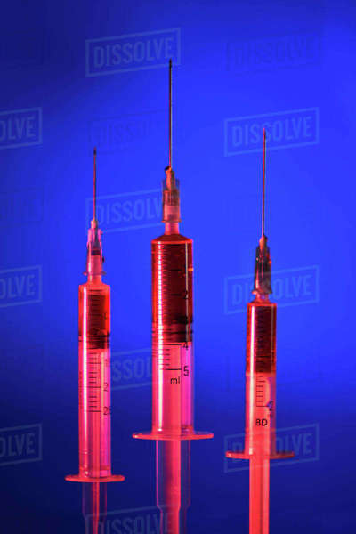 Set of few medical syringes filled with new vaccine medication composed ...