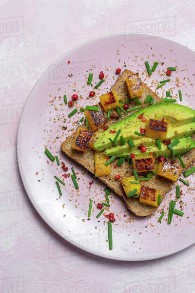 Homemade toasted bread from above with avocado, mango and aromatic ...