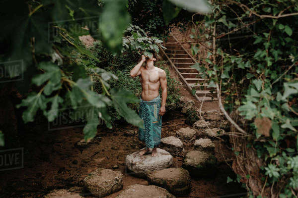 Full body unrecognizable muscular shirtless male in traditional ...