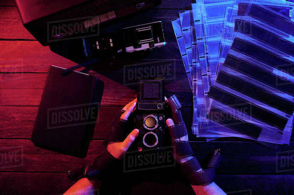 From above view of crop unrecognizable photographer with hands wrapped ...