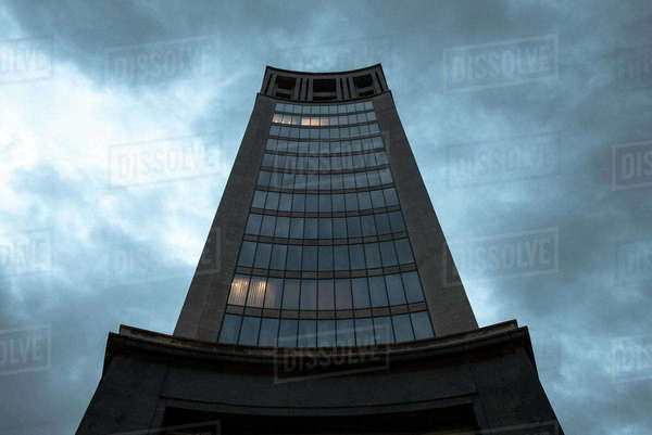 Perspective view from below of tall tower building with stone facade ...