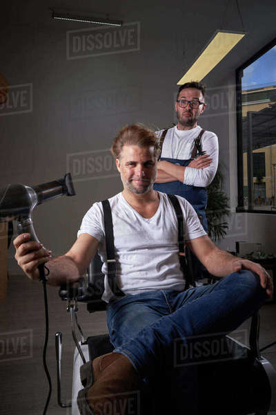 Low angle of shocked barber touching head and screaming while happy ...