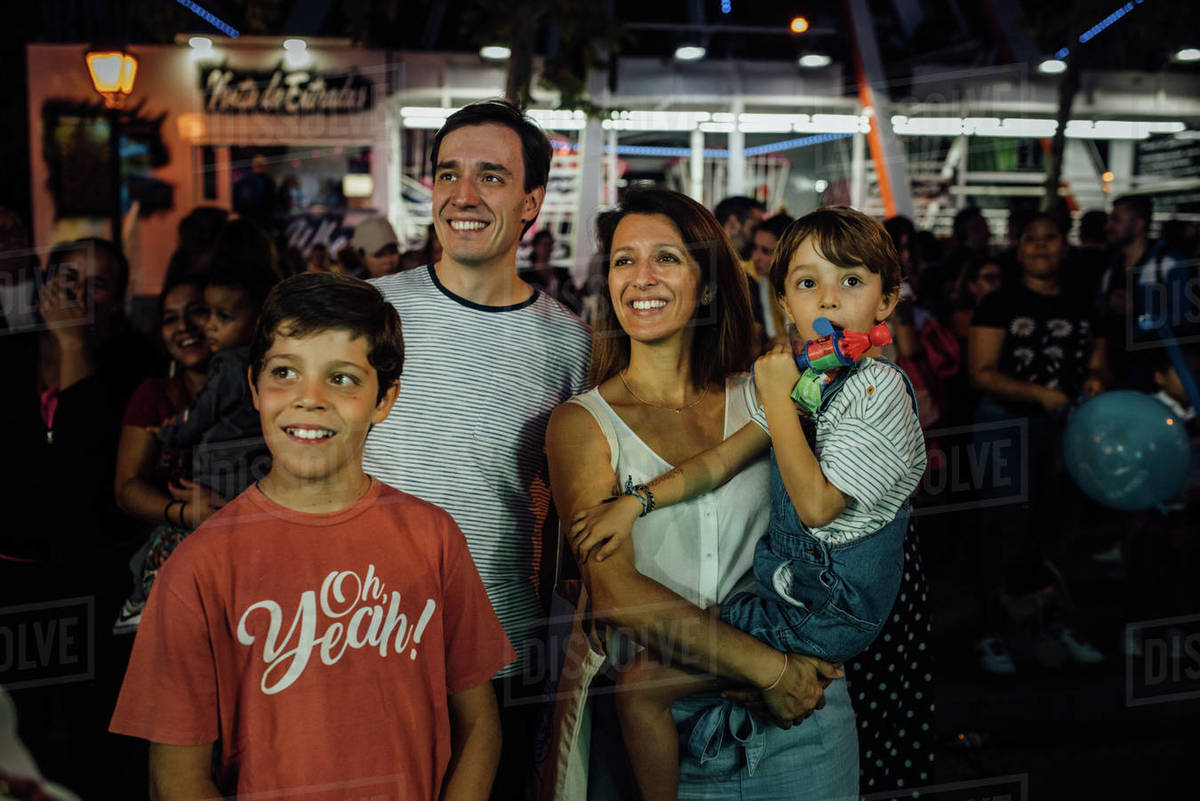Cheerful family on fairground in city - Royalty-free Stock Photo | Dissolve