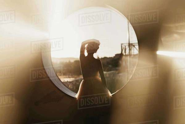Back view silhouette of anonymous graceful lady in dance costume ...