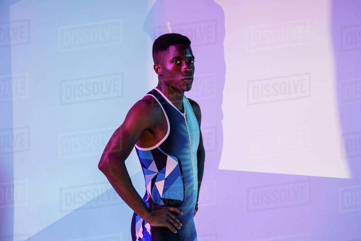 Full body side view of energetic young African American male sprinter ...