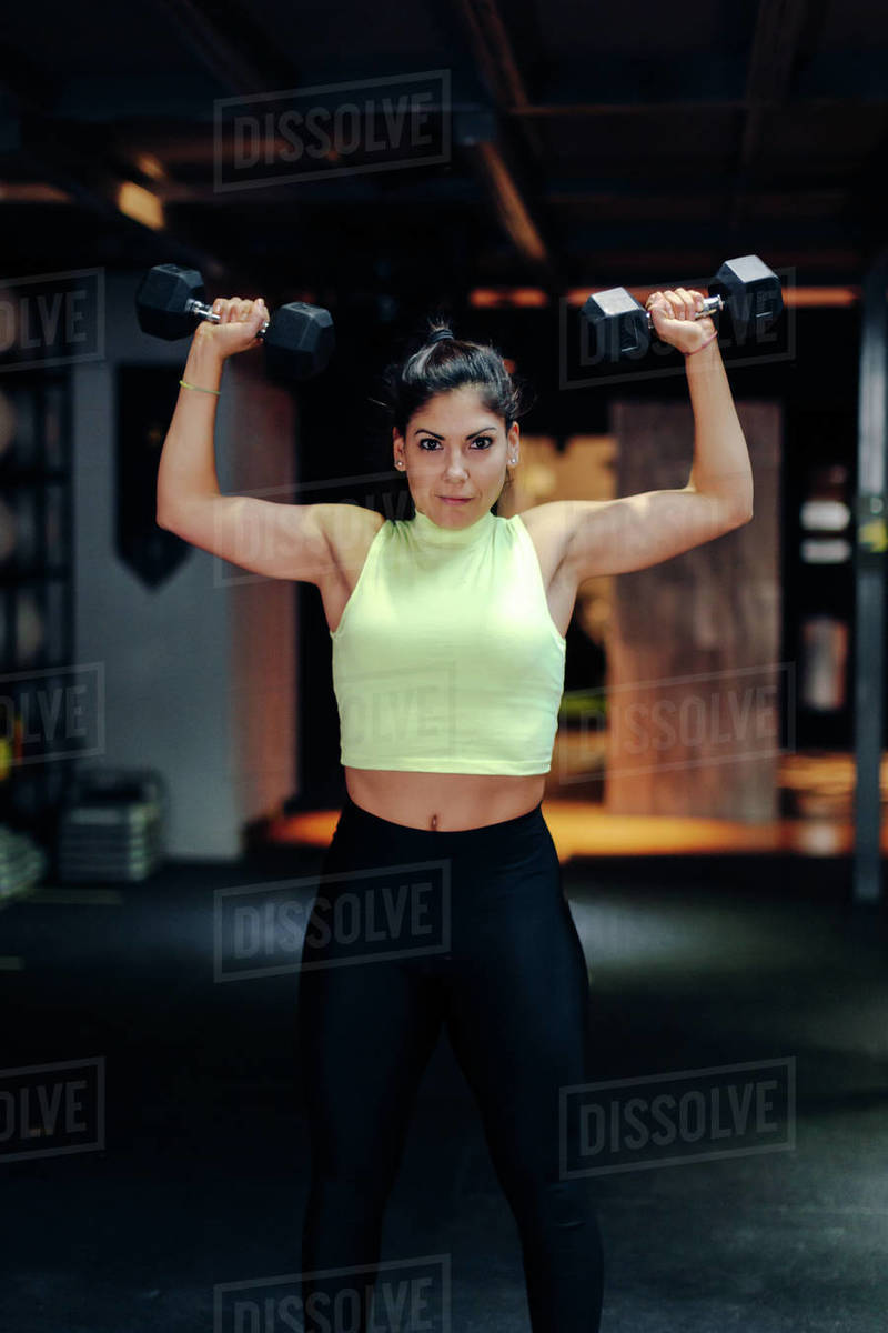 Full body of powerful muscular female athlete in sportswear doing ...