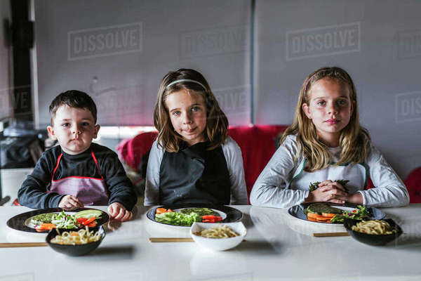 Boy and two girls waiting to eat tasty noodles with vegetarian cutlets ...