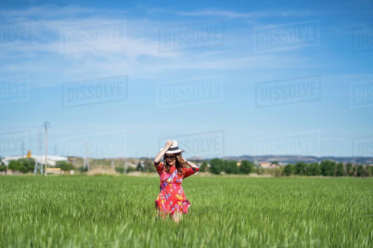 Lady standing in field - Royalty-free Stock Photo | Dissolve