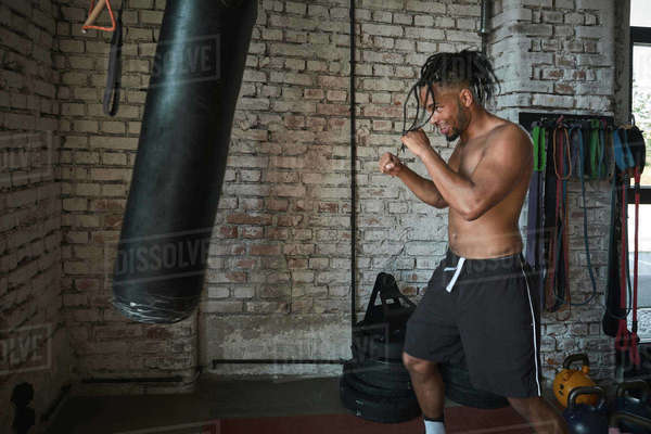 Black guy boxing in gym - Stock Photo - Dissolve