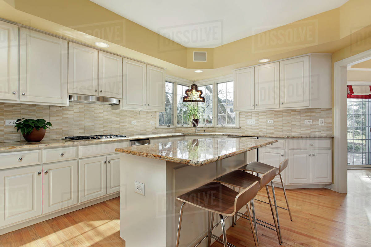 Kitchen in suburban home with white cabinetry - Royalty-free Stock ...