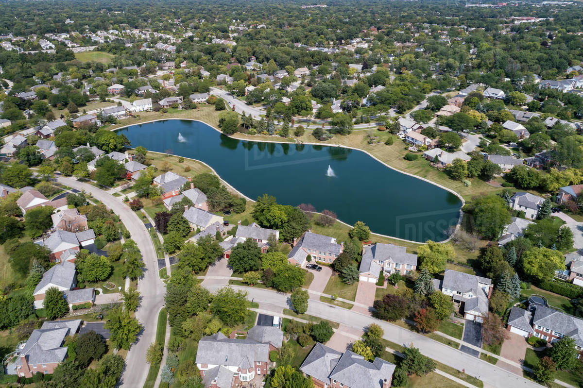 Aerial view of a neighborhood with a large pond in suburban Chicago ...