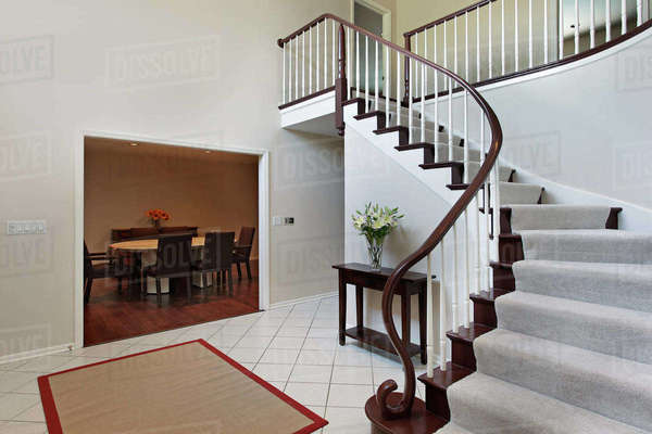 Foyer in suburban home with curved staircase - Royalty-free Stock Photo ...