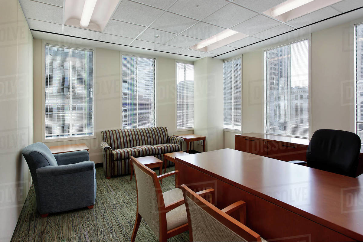 Corner office in downtown building with executive desk - Royalty-free ...