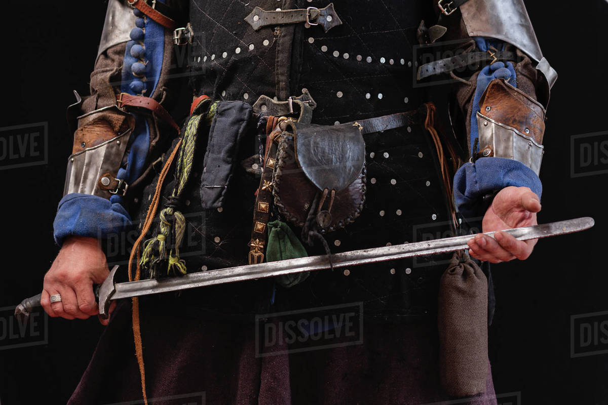 Close-up portrait of a medieval knight with two sword and with a ...