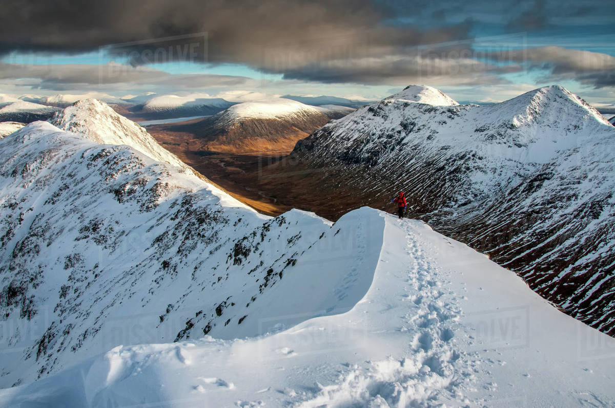 A female walker approaching the summit of Stob Dubh on Buchaille Etive ...
