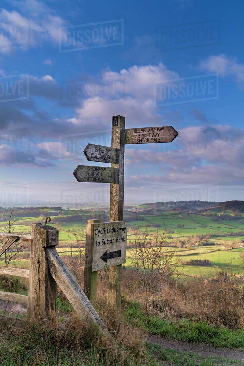 Signpost and distant view of the Vale of York from Whitestone Cliff ...