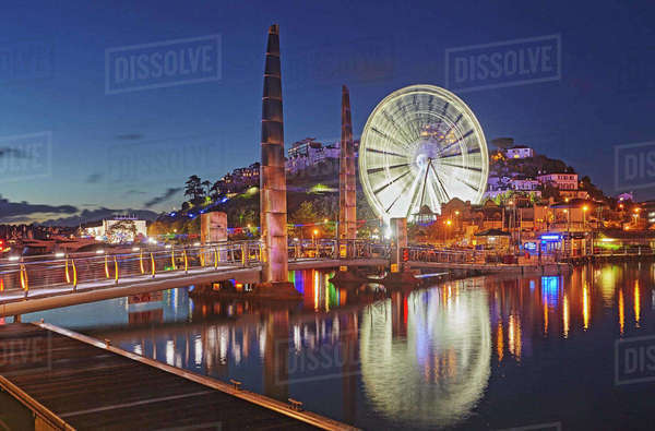 An atmospheric dusk view across Torquay Marina to the town of Torquay ...