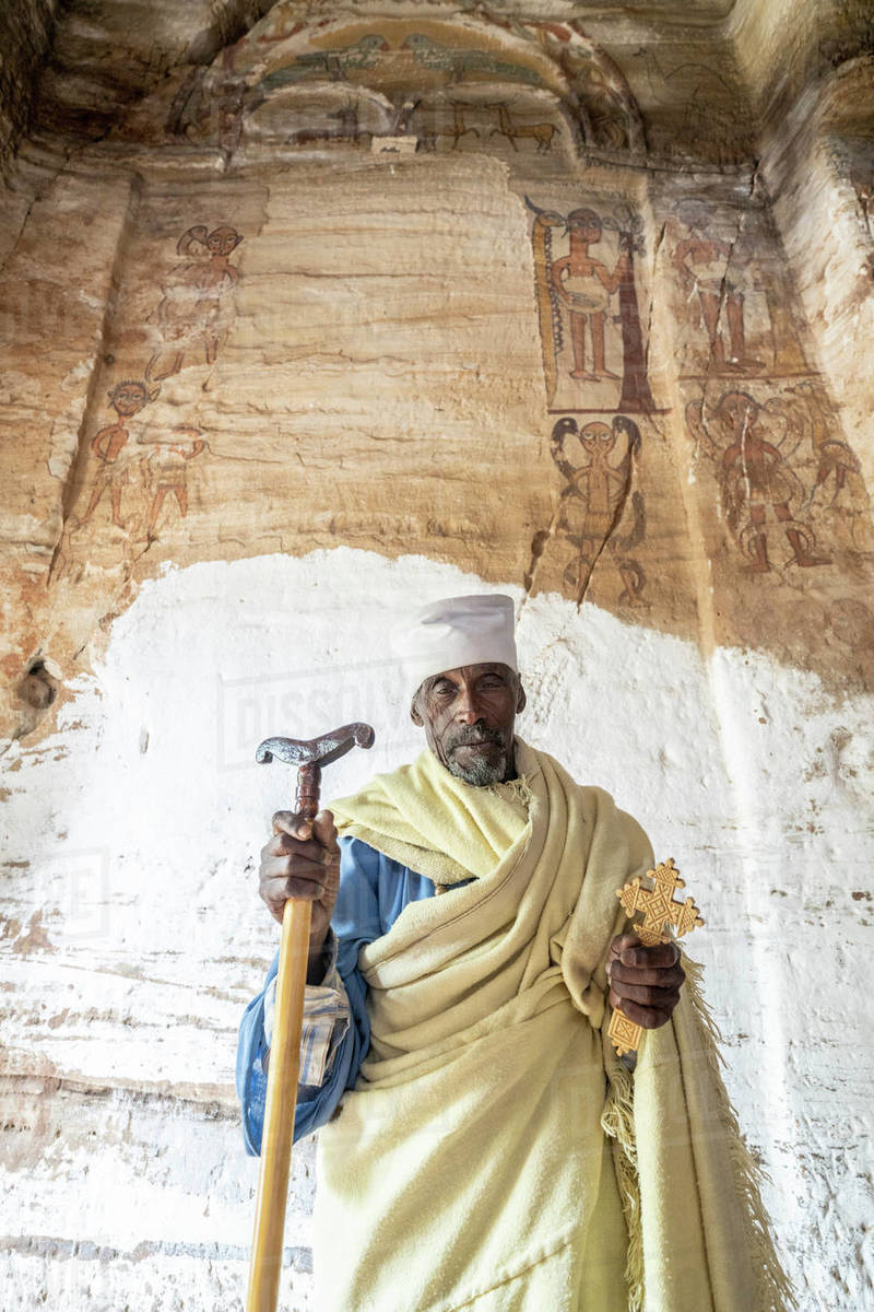 Orthodox priest holding the hand cross and prayer stick in Maryam ...