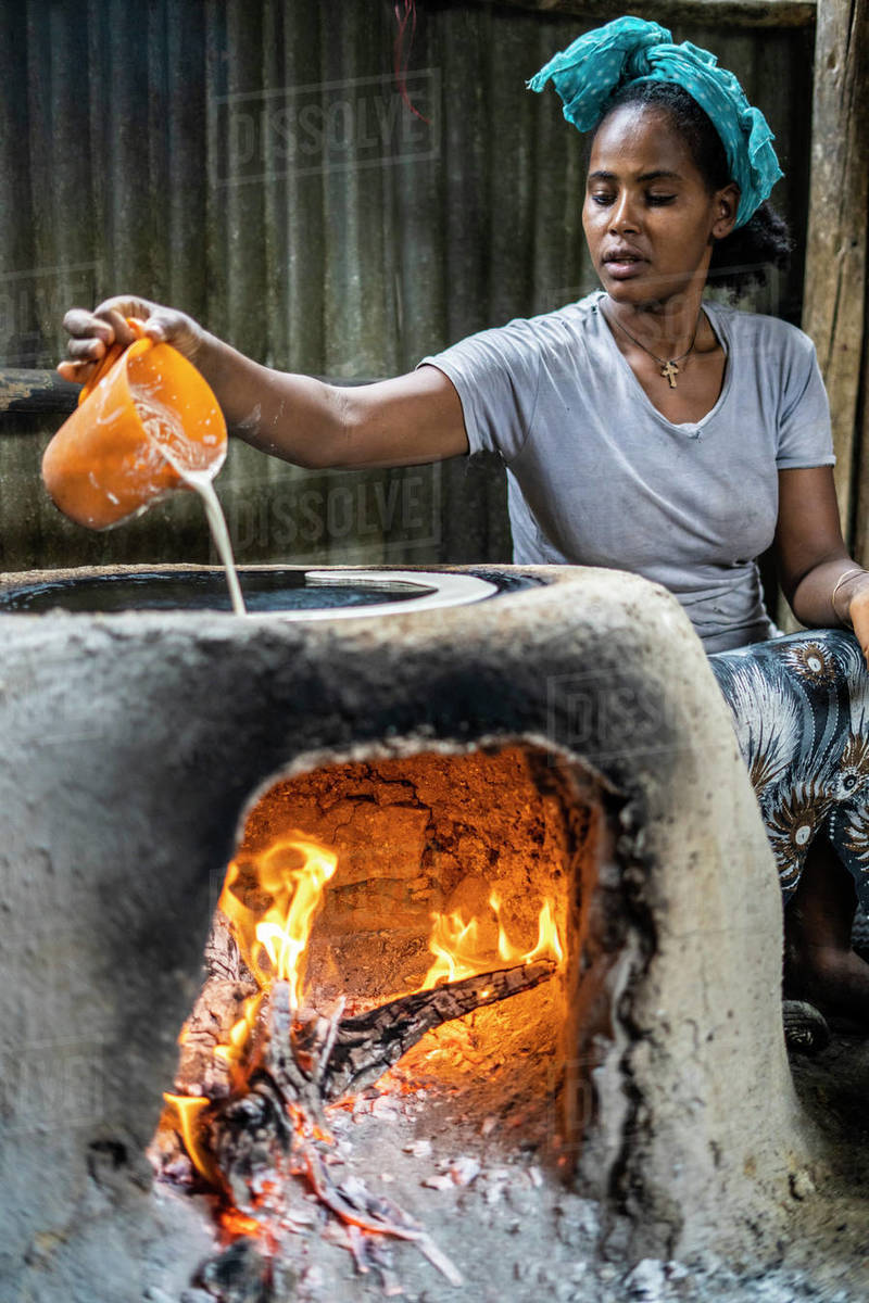 Woman making injera bread on traditional oven, Berhale, Afar Region ...