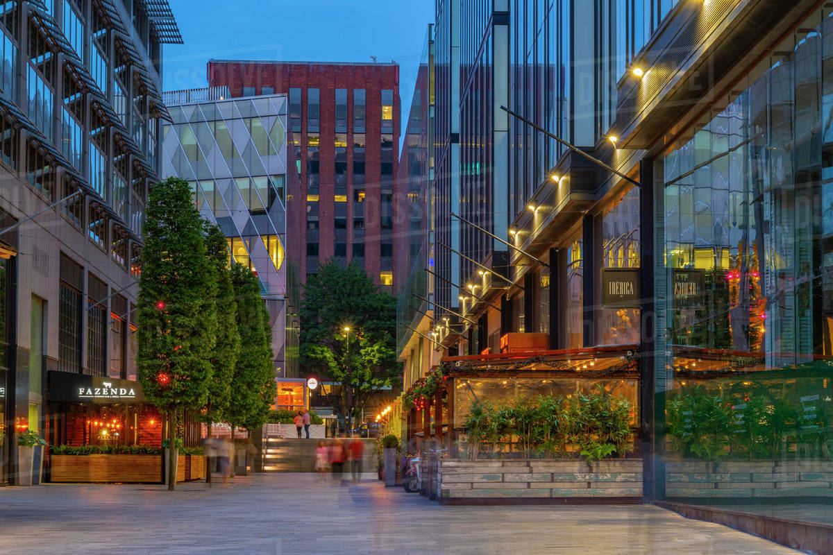 View of restaurants and buildings in Springfields at dusk, Manchester ...