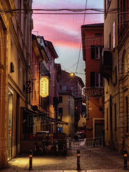 An alley in Bologna at sunrise, with pink clouds in the sky, Bologna ...