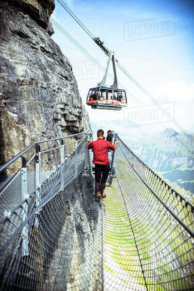 One person looking at the cable car from the Thrill Walk cliff pathway ...