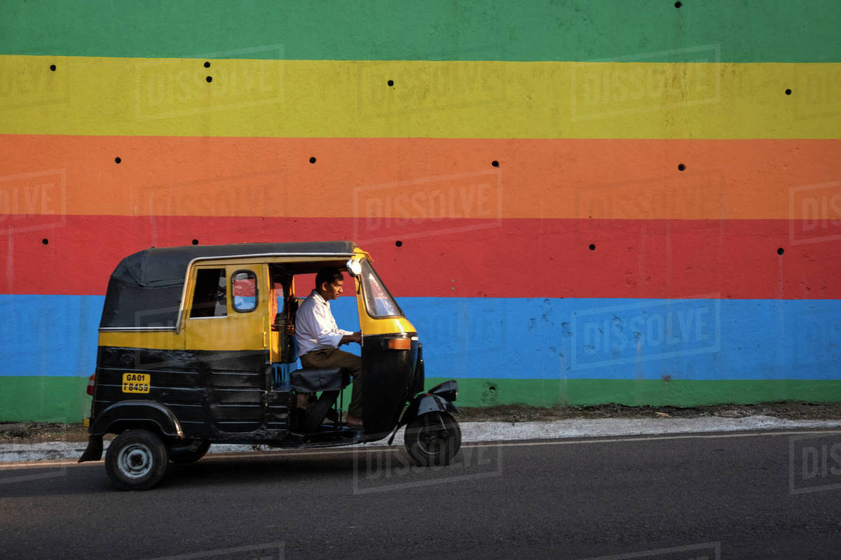 Indian Tuk Tuk passing a brightly painted wall in Panjim City, Panjim ...