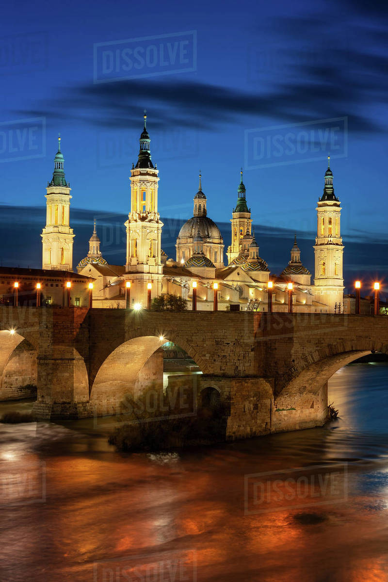 Basilica del Pilar Cathedral with stone bridge crossing Ebro River at ...