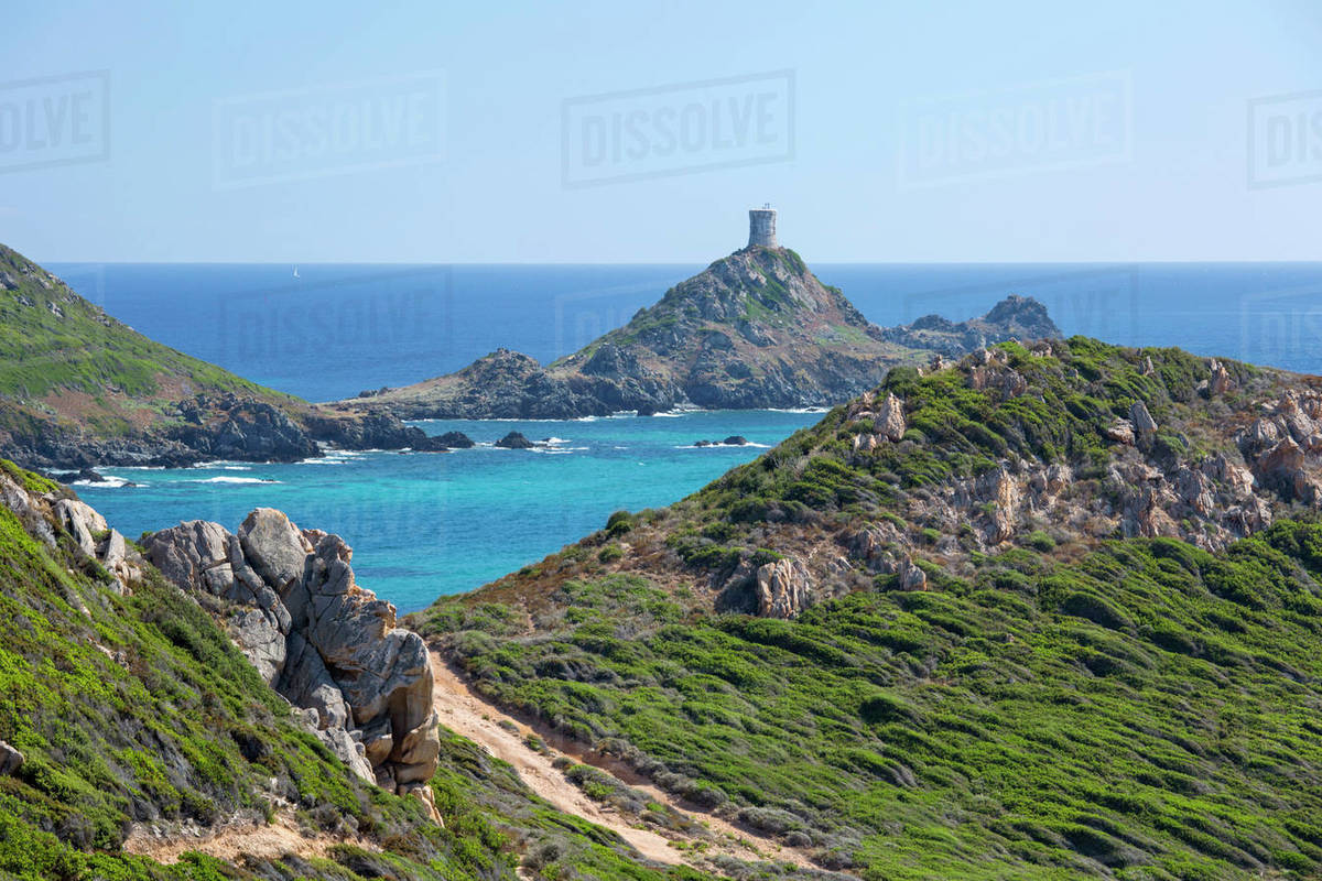 View from hillside across bay to the ruined Genoese watchtower at ...