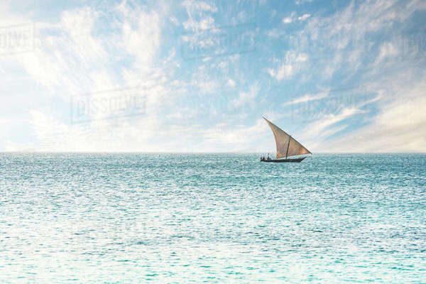 Traditional African dhow sailing in the calm waters of the Indian Ocean ...