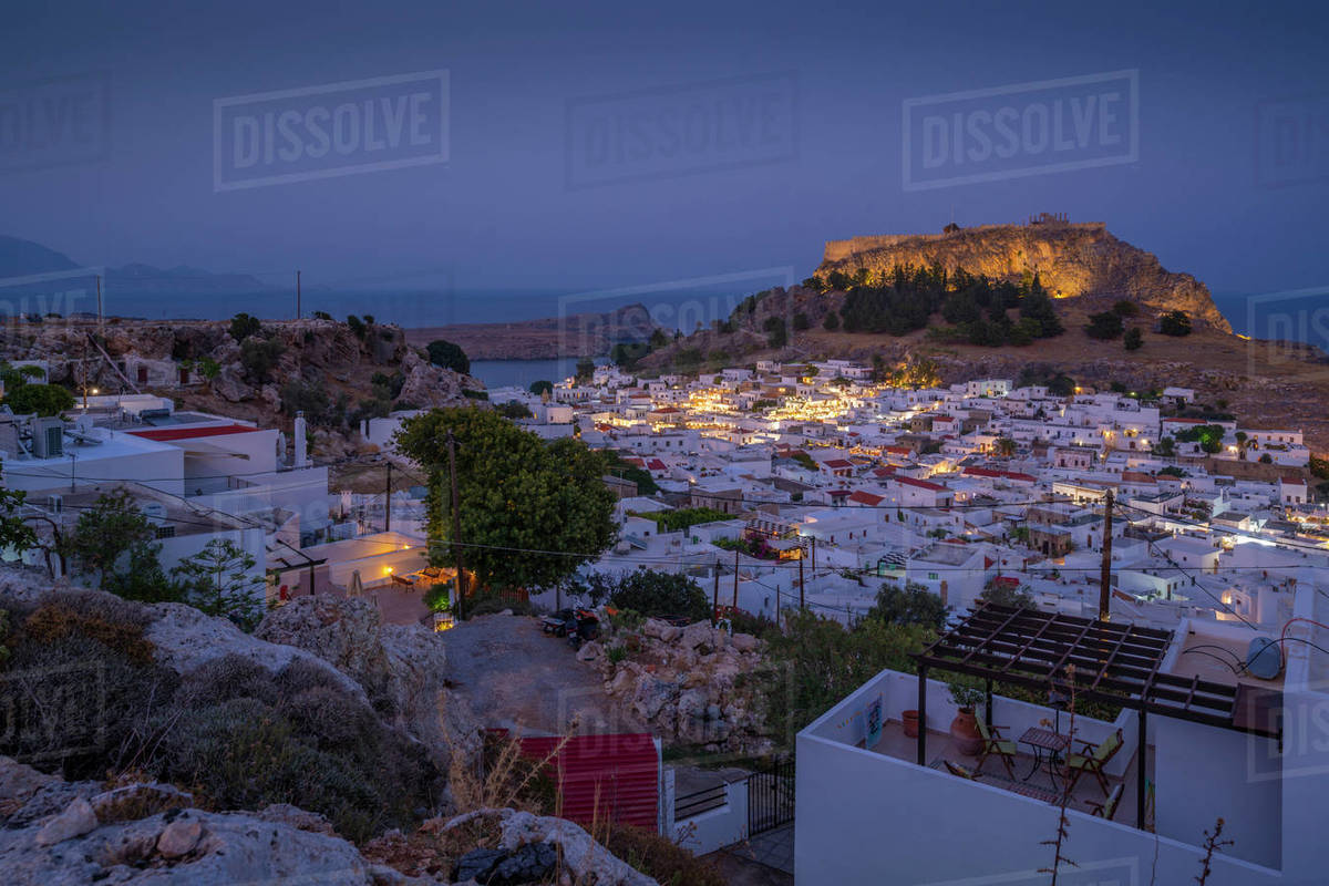 View of Lindos and Lindos Acropolis from elevated position at dusk ...