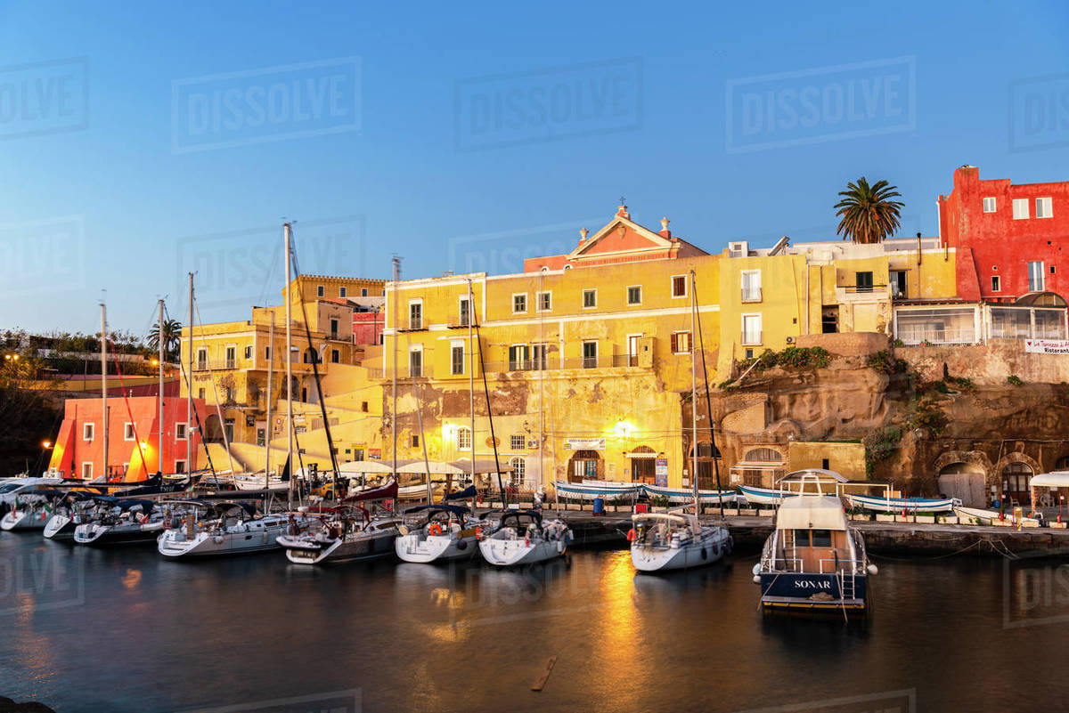Old Roman harbour of the colourful village of Ventotene at dawn ...