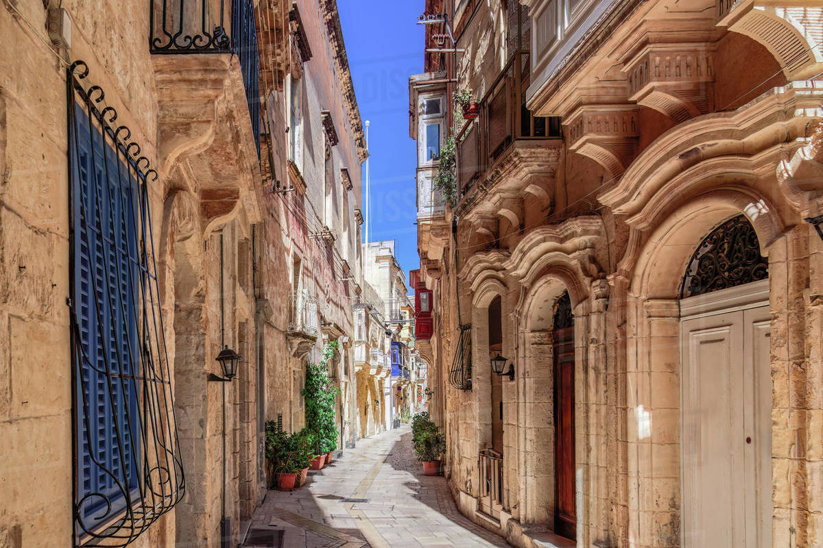 Traditional Maltese limestone buildings with coloured balconies in the ...