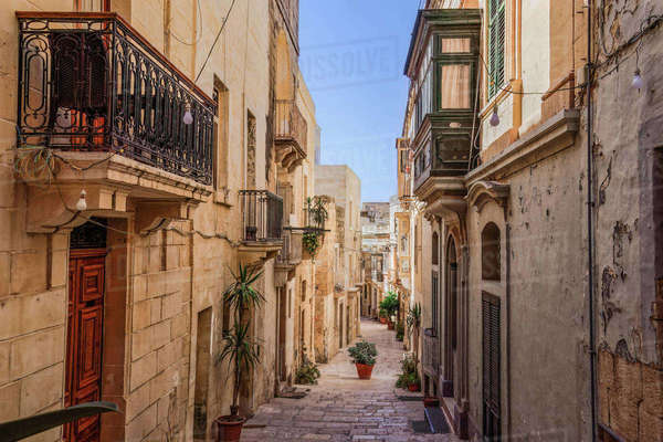Traditional Maltese limestone buildings with coloured balconies in the ...