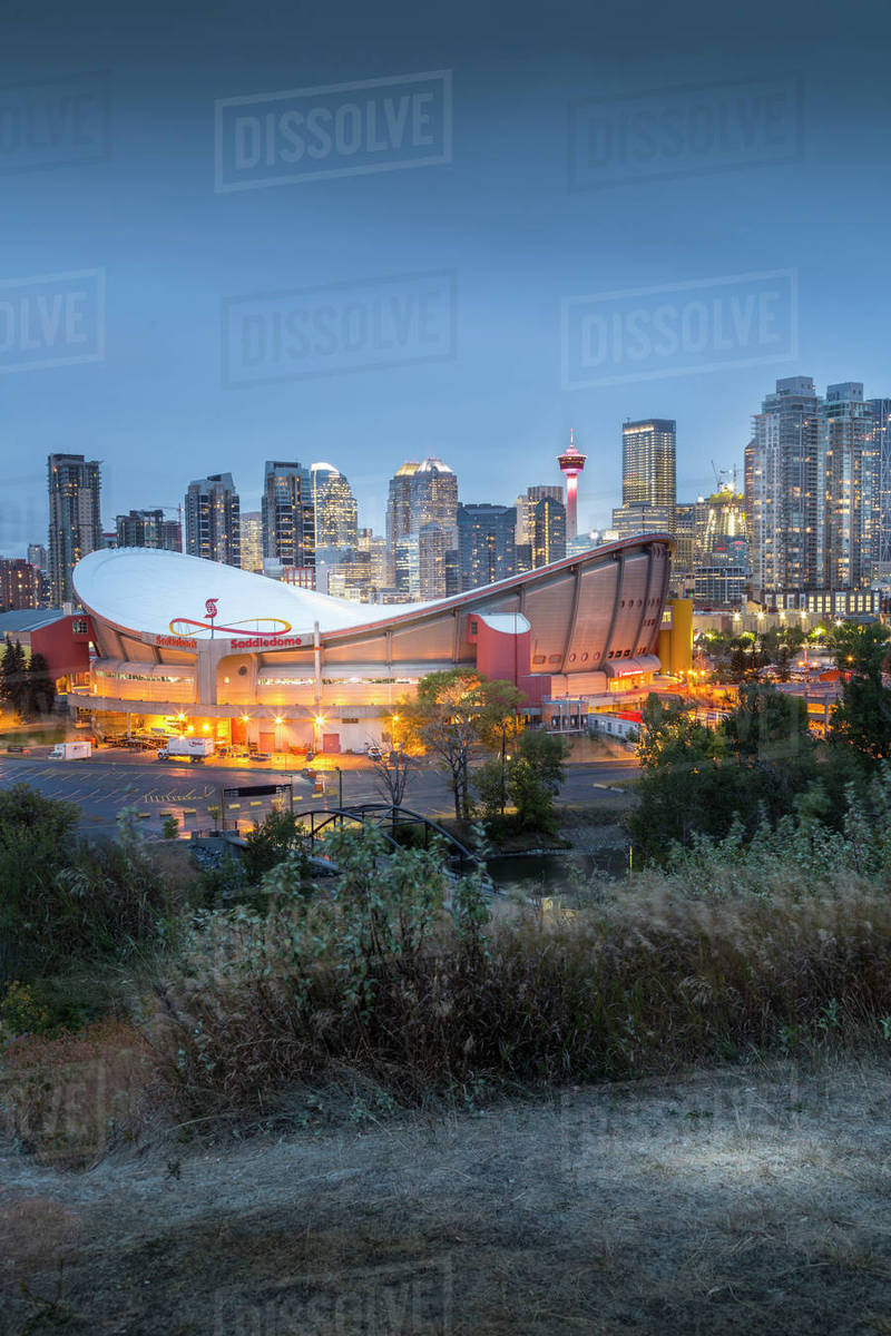 View of the Saddledome and Downtown skyline from Scottsman Hill at dusk ...