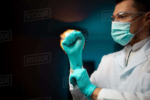 closeup scientist or Doctor wearing protective glove in lab. - Royalty ...