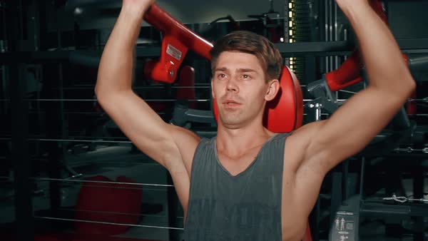 Man pumping muscles in gym. Sport, fitness, lifestyle, beauty concept ...